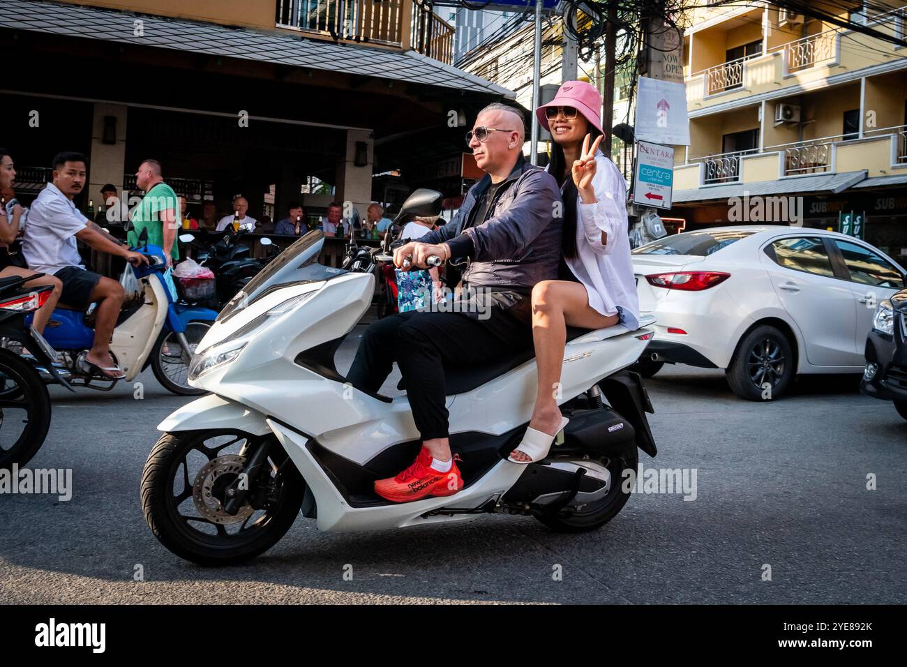 A western man makes his way along Soi Buakhao, Pattaya Thailand with a young thai lady on the ...