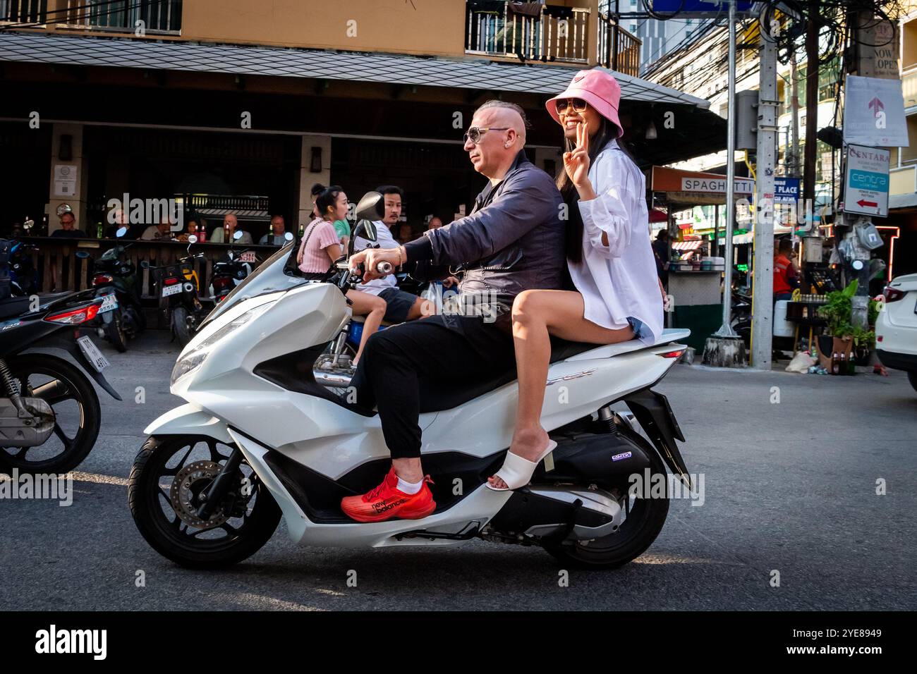 A western man makes his way along Soi Buakhao, Pattaya Thailand with a young thai lady on the ...