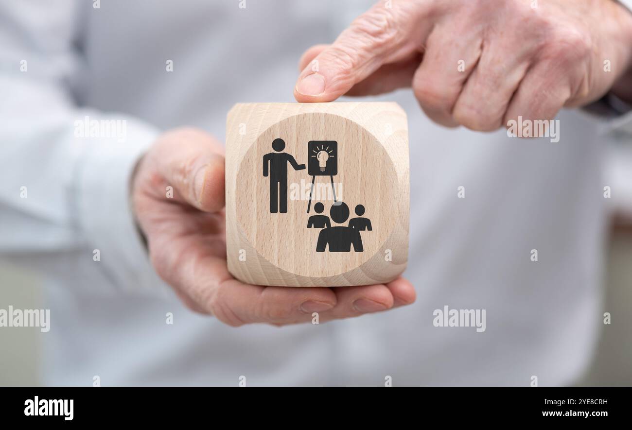 Hand holding a wooden cube with symbol of knowledge sharing concept ...