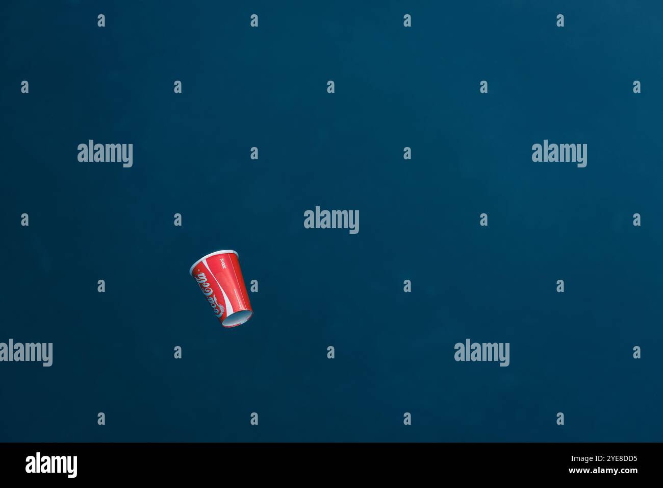 Red paper cup from Coca-Cola floats in a blue sea. Top view Stock Photo ...