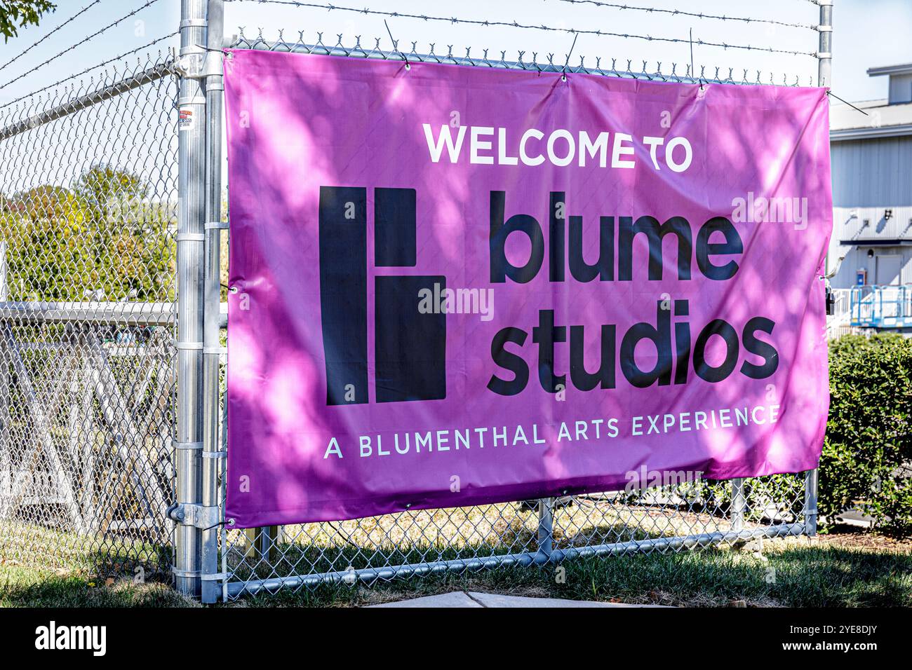 Charlotte, NC, USA-Oct. 20, 2024: Blume Studios flag hung on gate. "Welcome to blume studios, A ...