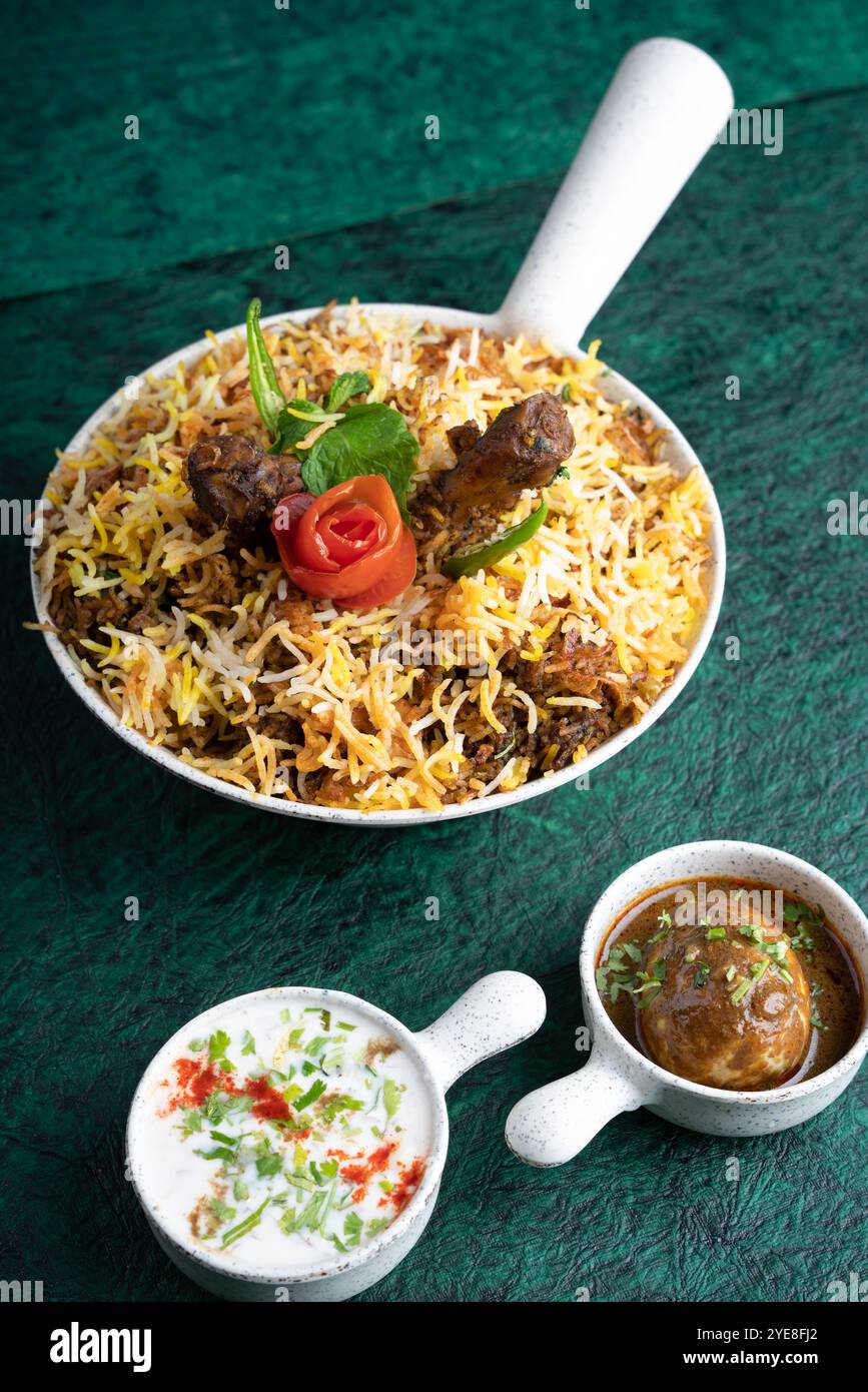 A bowl of Spicy Indian Rice with sides and curd Stock Photo - Alamy