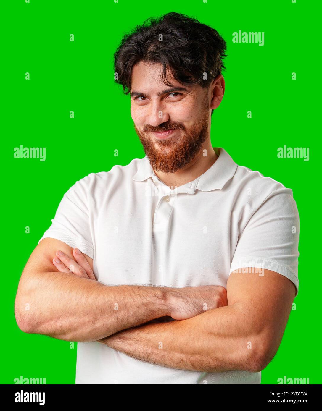 A man with a beard smiles confidently against a bright green background ...