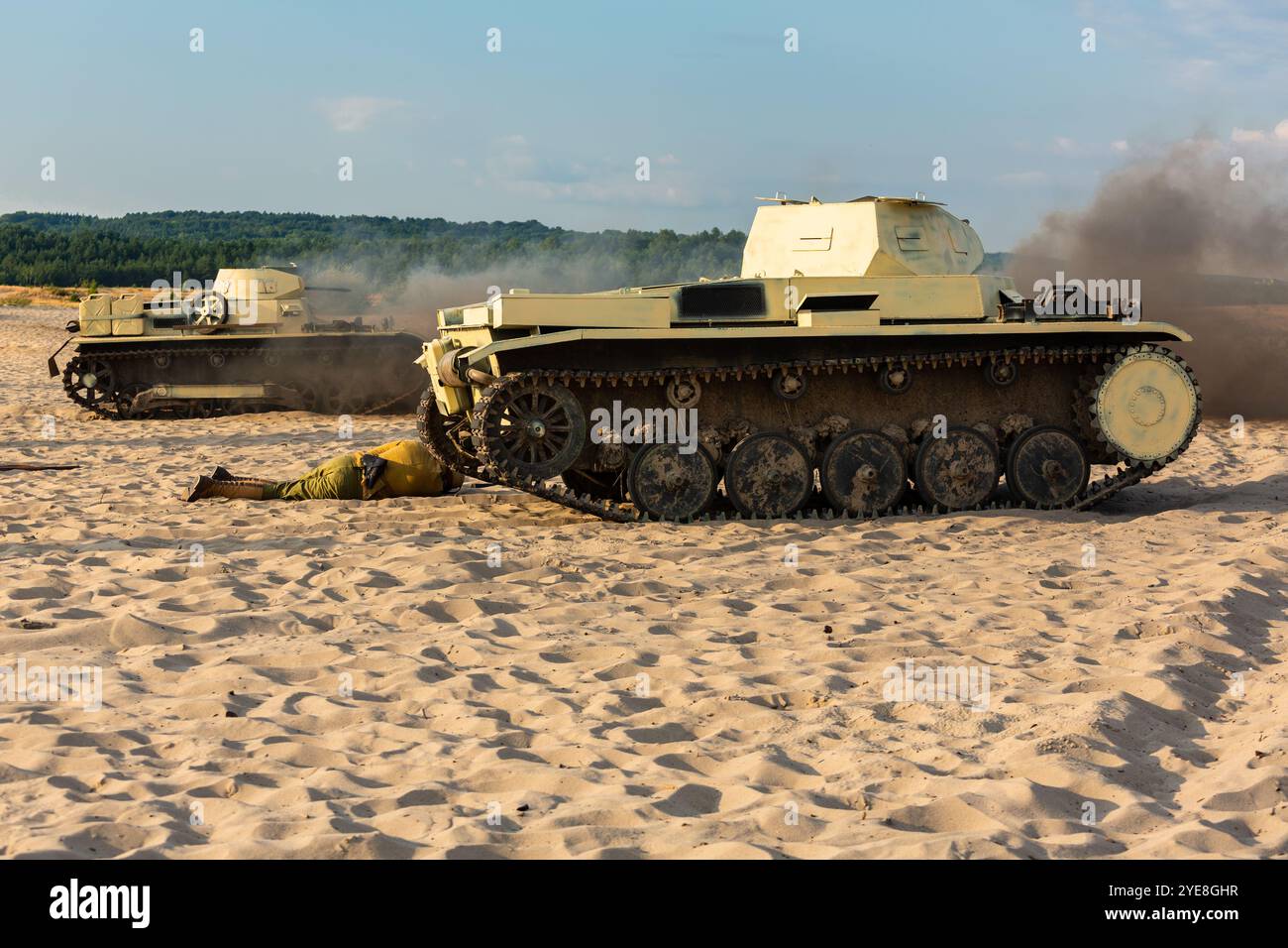 Two German tanks on the battlefield in the sand, dust and smoke ...