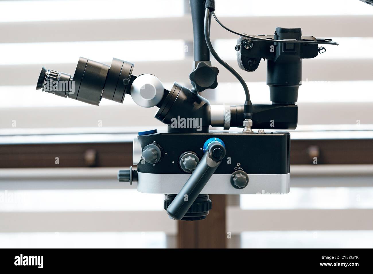 A detailed view of a dental microscope prepared for a procedure in a ...