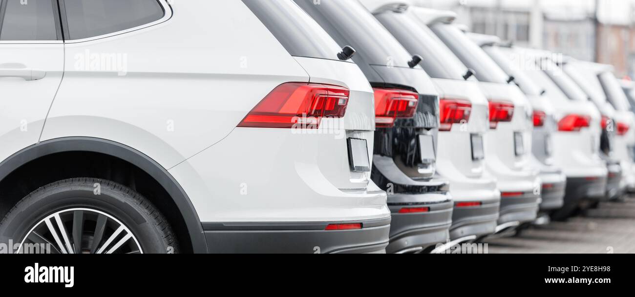 Back view many modern new SUV cars fleet stock at dealership parking ...