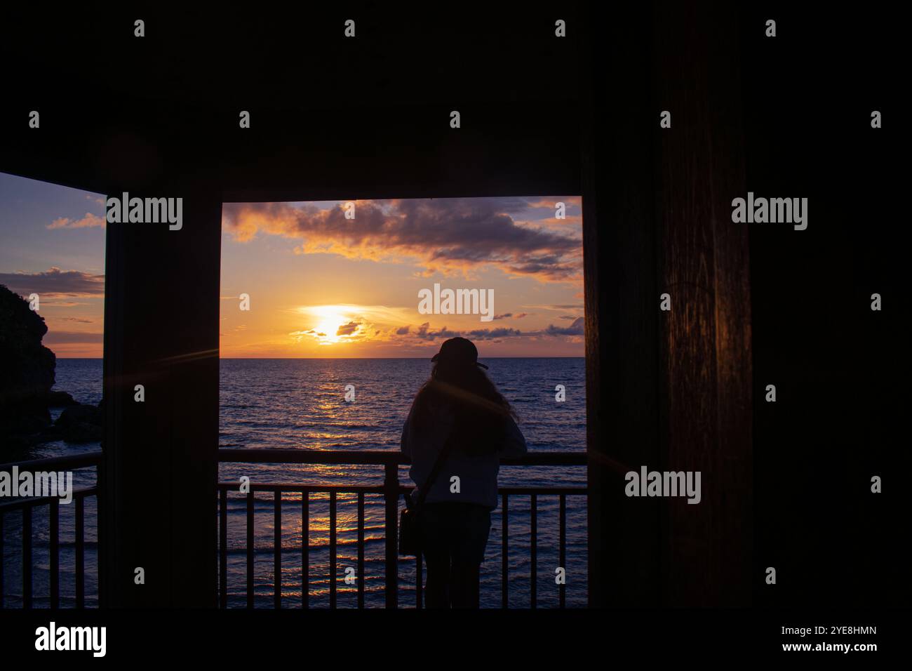 Silhouette of a woman at sunset on a gazebo by the beach. Bil-At Point ...