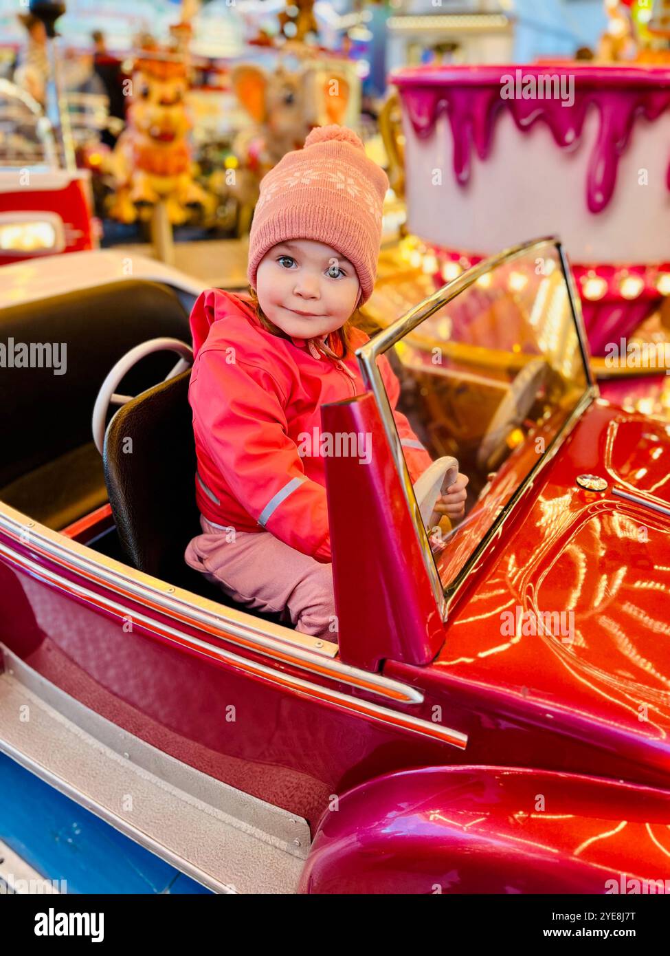 Little girl having fun in a carousel Stock Photo - Alamy