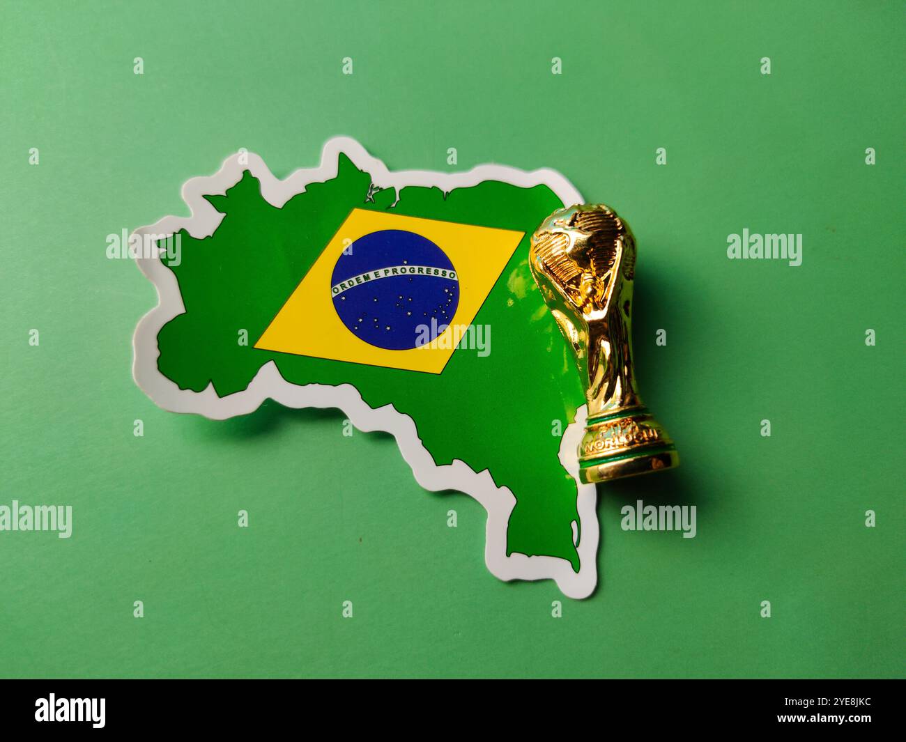 Closeup brazil flag stickers with world cup trophy on a green ...