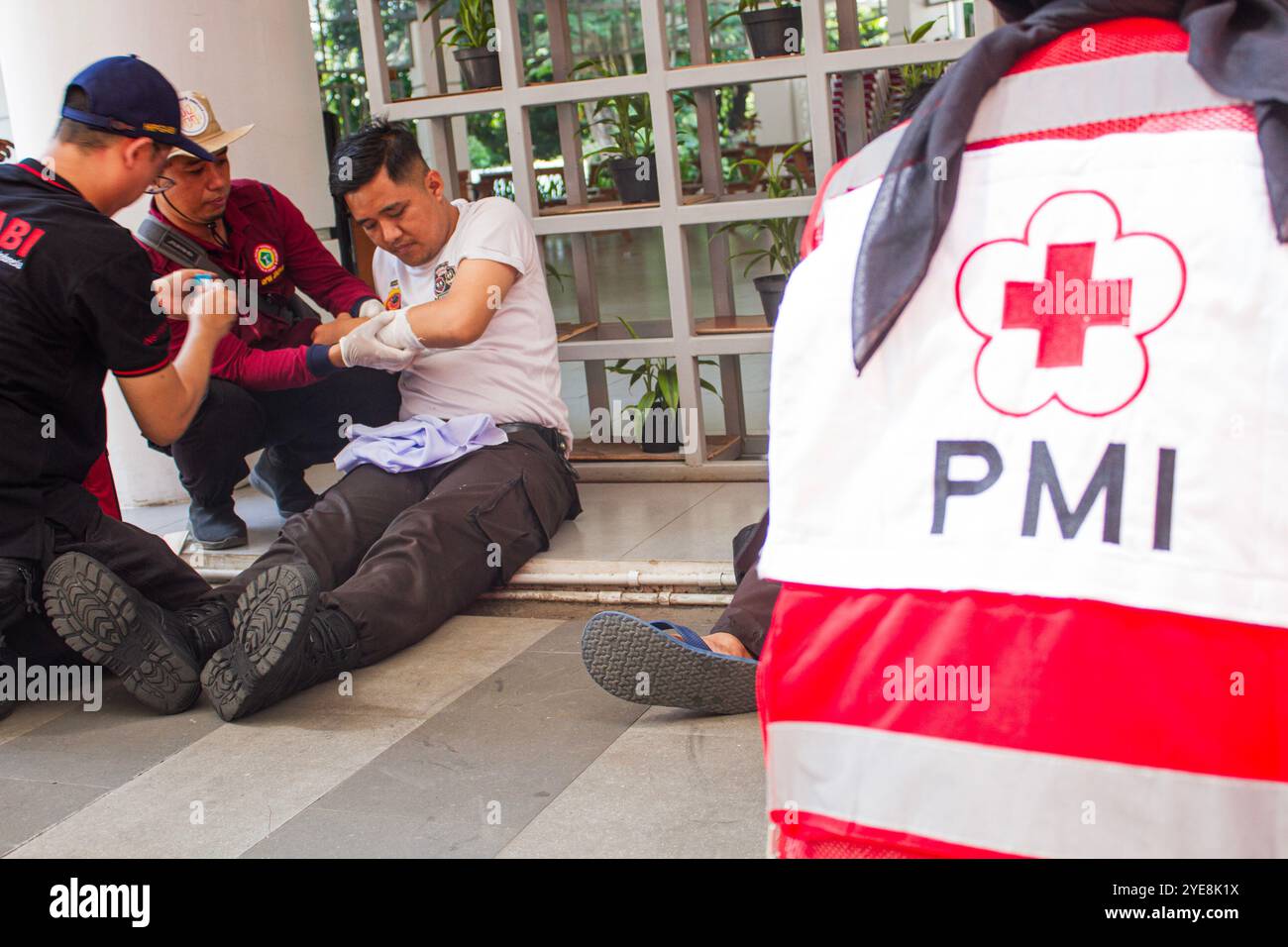 Health worker treats a man roleplaying as injured victim an earthquake ...