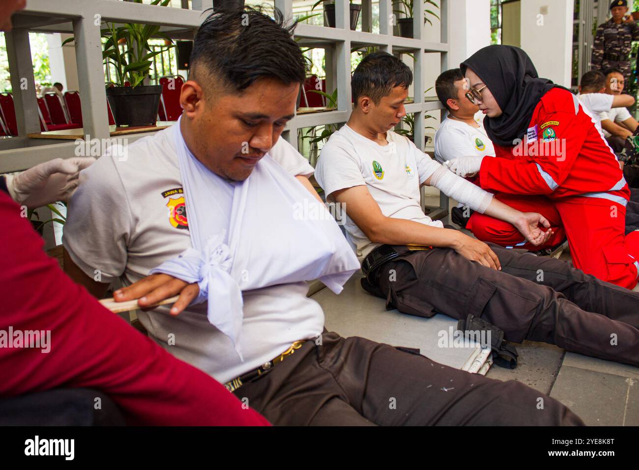 Health worker treats a man roleplaying as injured victim an earthquake ...