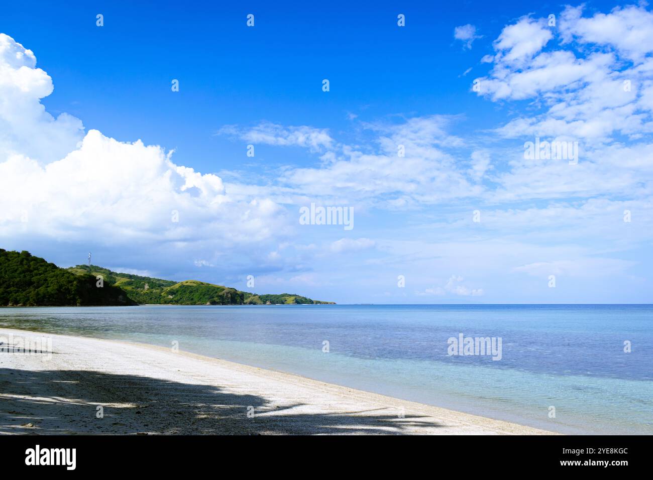 Tropical white sand beach in a blue sky sunny day. Aglicay, Romblon ...