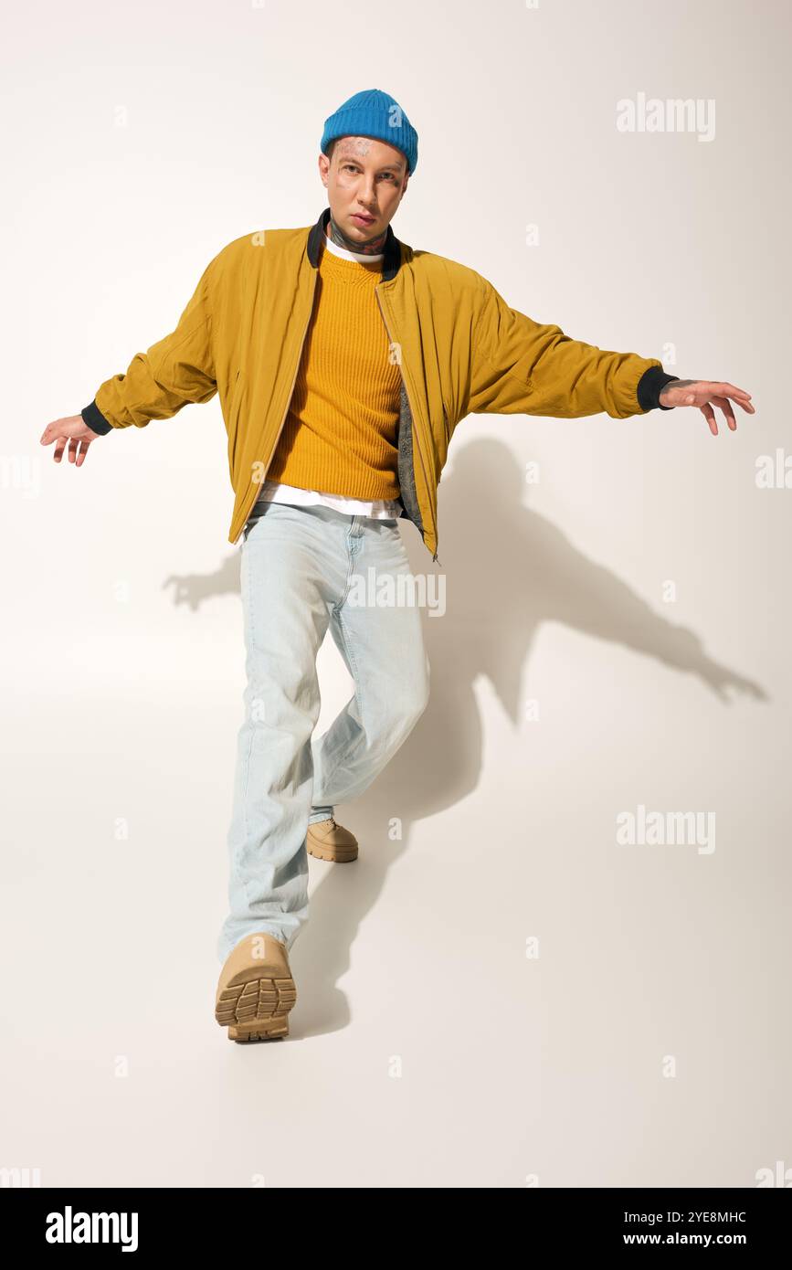 The young man confidently poses against a neutral background ...