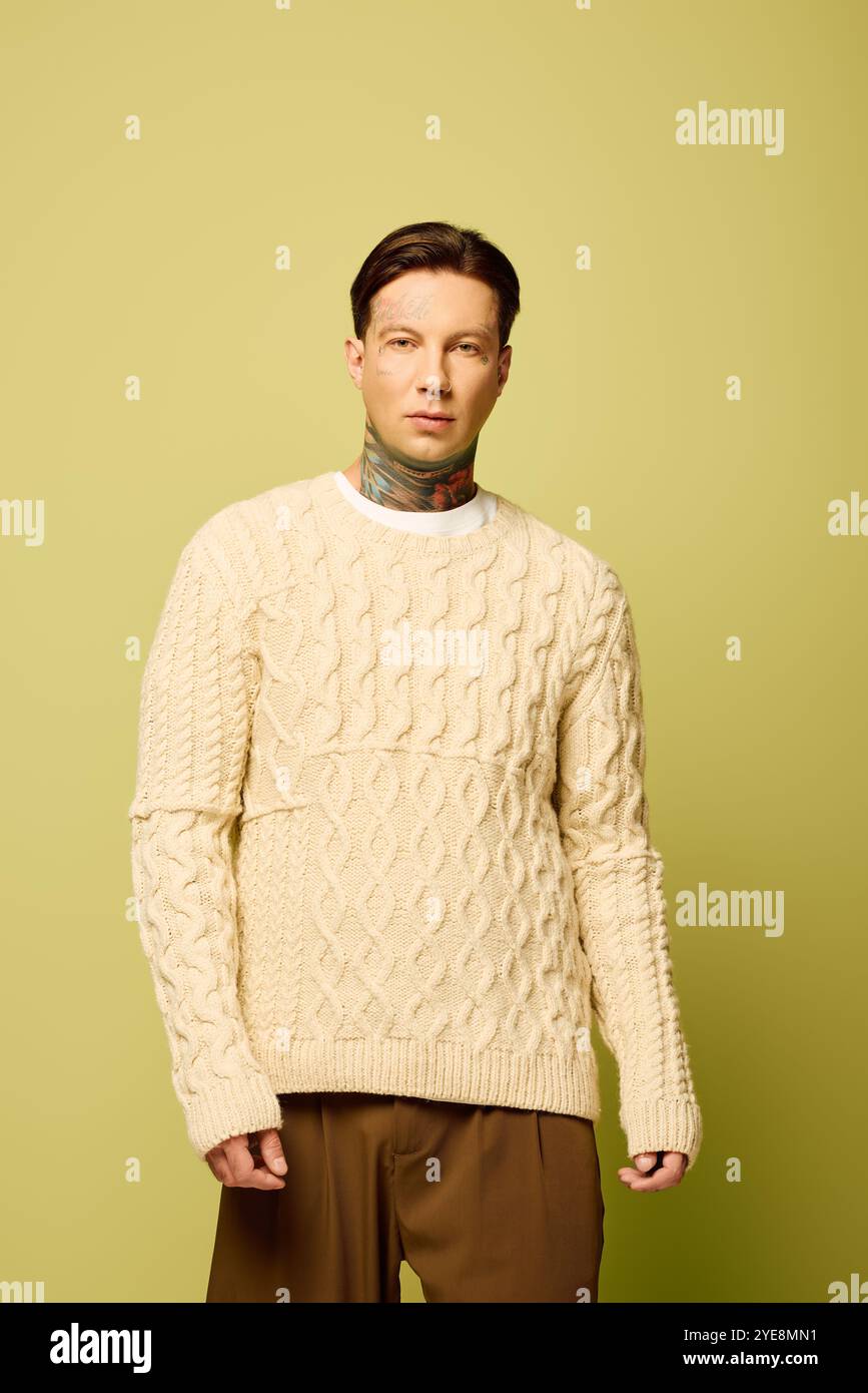 The young man flaunts his unique tattoos in a cozy sweater, radiating ...