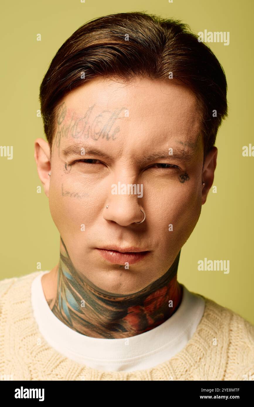 This young man showcases his intricate facial and neck tattoos while ...
