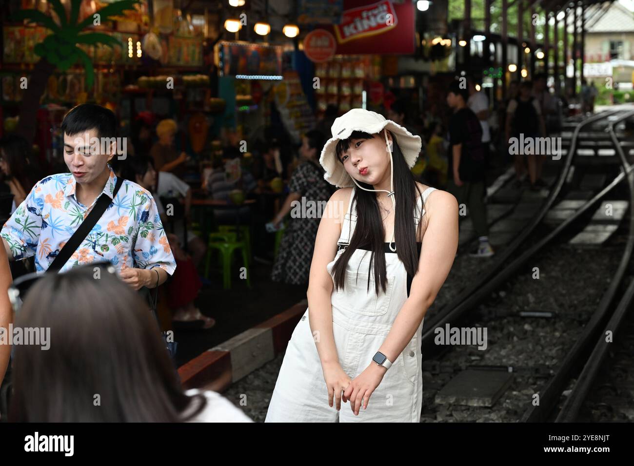Railway market Thailand , Portrait of Asian Girl standing in railway track and posing with charm ...