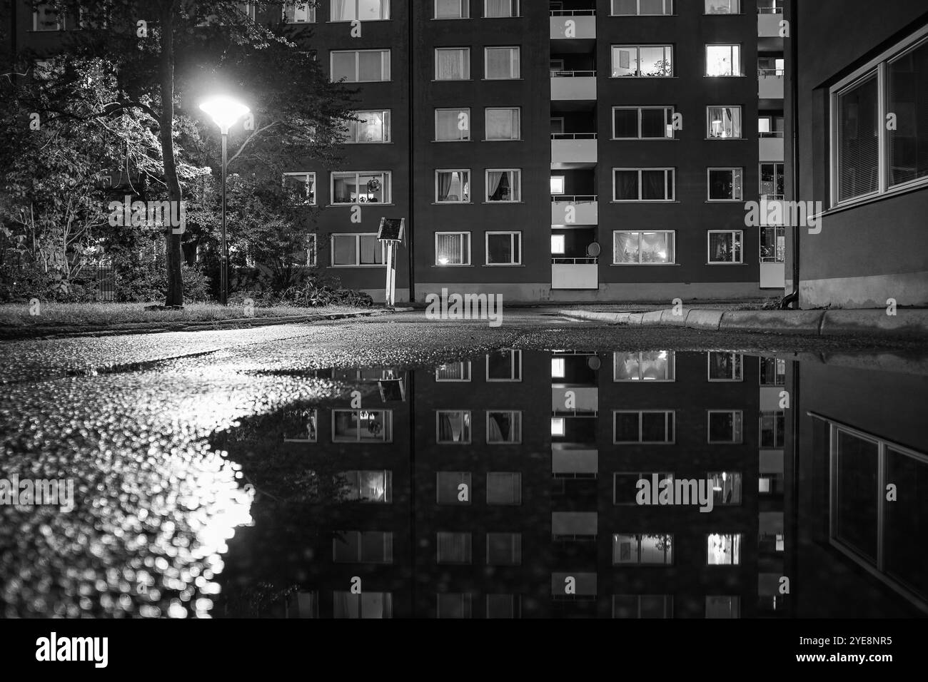 Close up of a puddle of water in front of apartment building during the ...