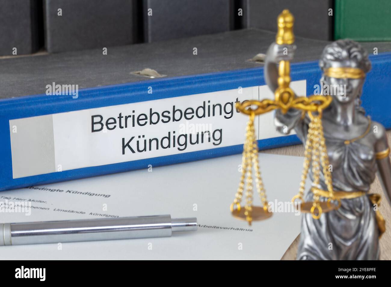 Notice of termination in front of a folder labelled BETRIEBSBEDINGTE ...