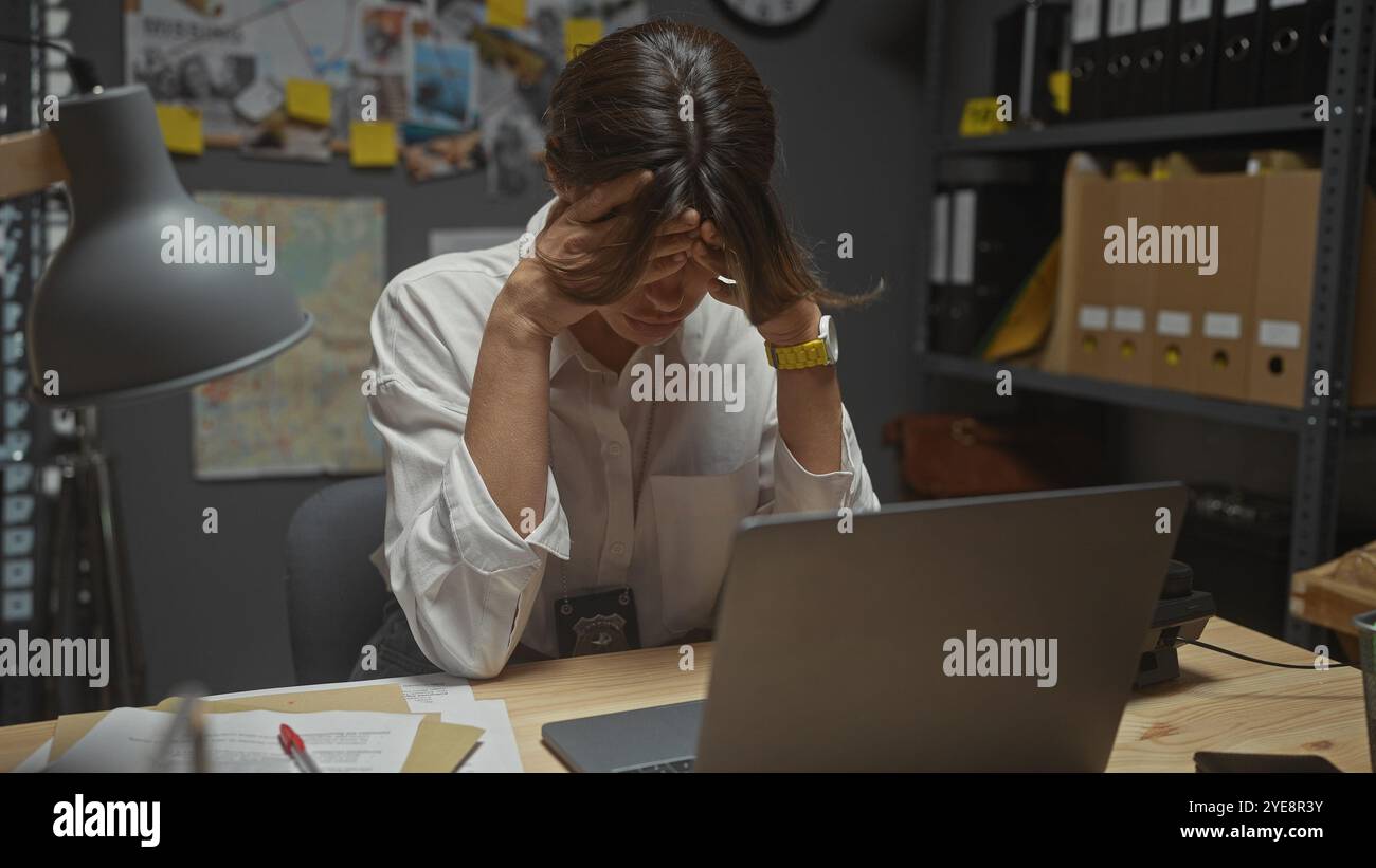 A stressed woman detective indoors analyzes evidence at a cluttered ...