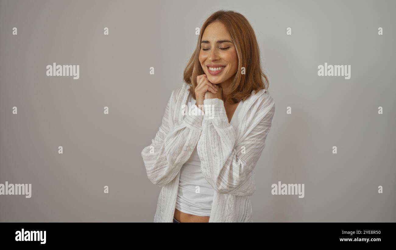 Young brunette hispanic woman smiling attractively in a white shirt ...