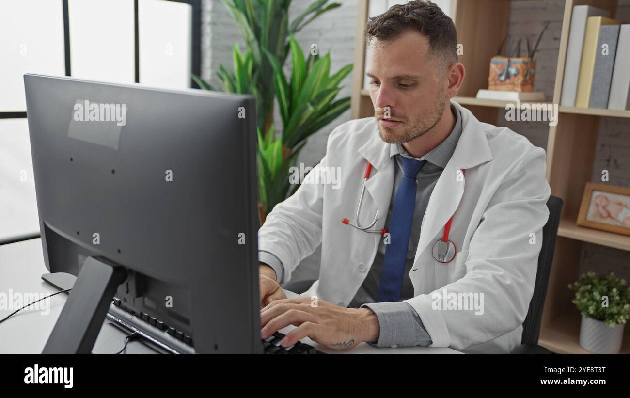 A professional hispanic man with a beard works on a computer in a ...