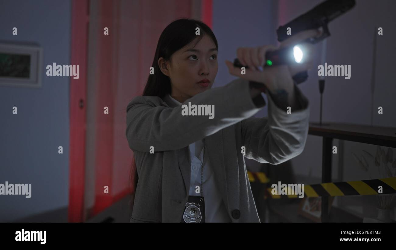 Asian woman detective searches indoor crime scene with flashlight and ...