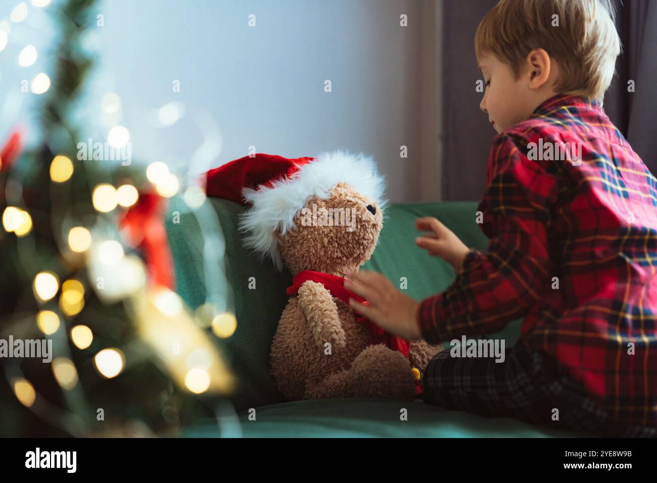 cute little boy dressing up teddy bear Stock Photo - Alamy