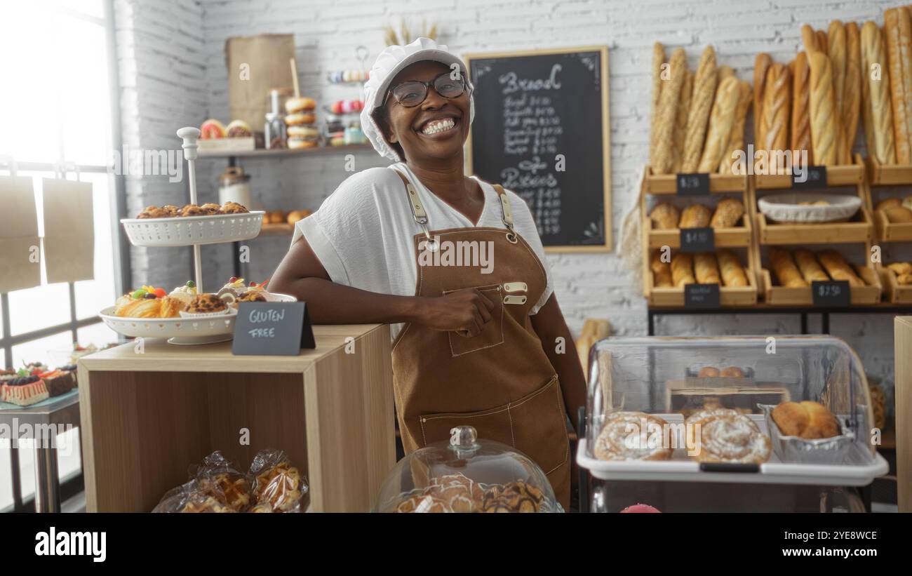 Woman smiling behind bakery counter hi-res stock photography and images ...