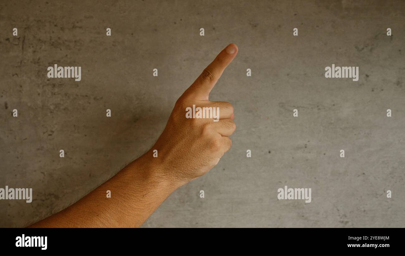 Human hand pointing finger against concrete wall background Stock Photo ...