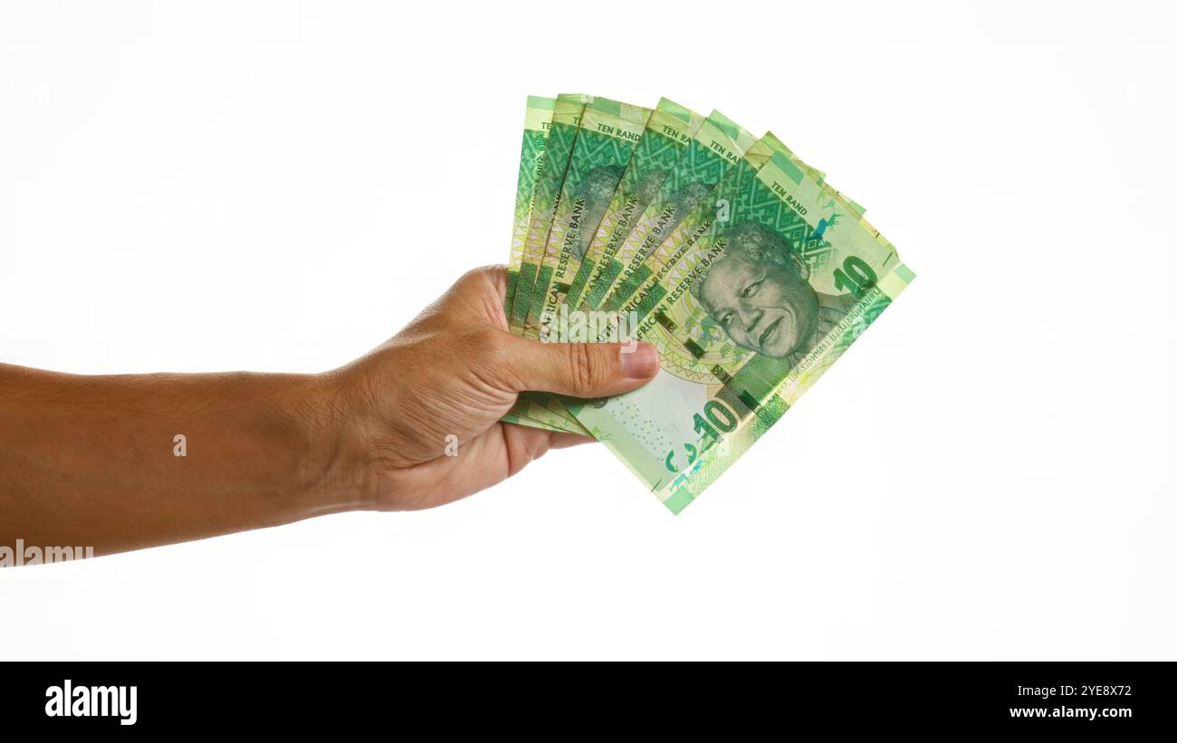 Hand holding south african rand notes over isolated white background ...