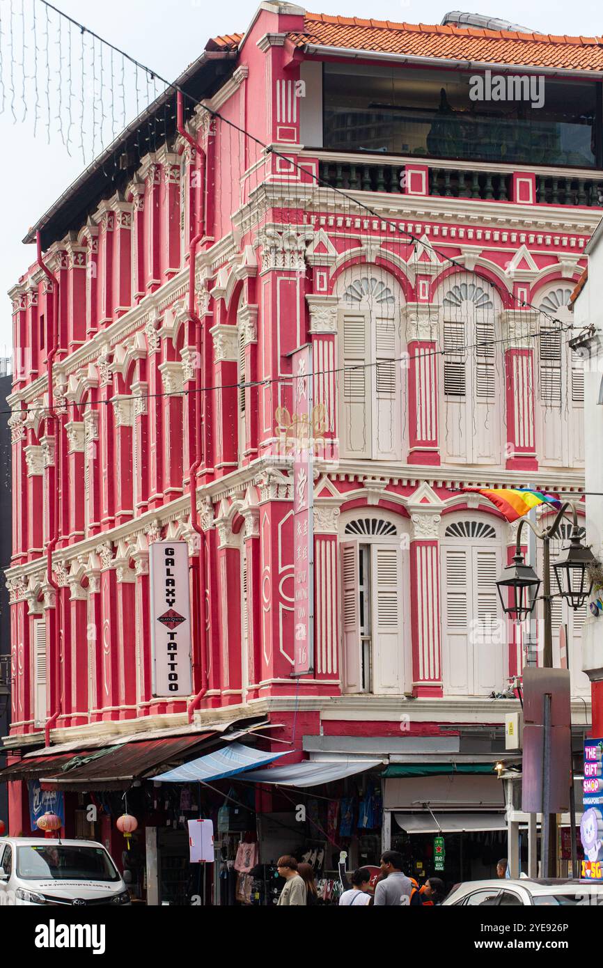 Vertical. Three storey shophouses architecture facade in pink colour ...