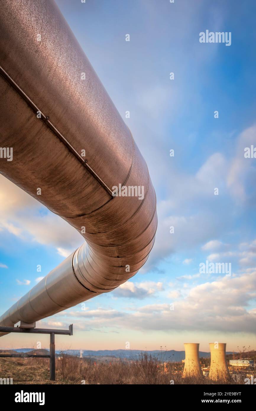 Pipeline of a geothermal power plant and two cooling towers in ...