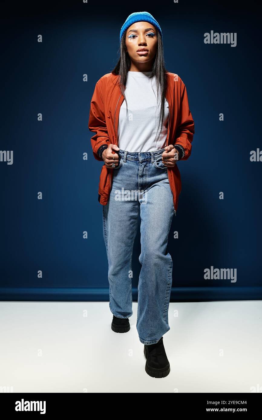 Trendy young woman confidently strolls hi-res stock photography and ...