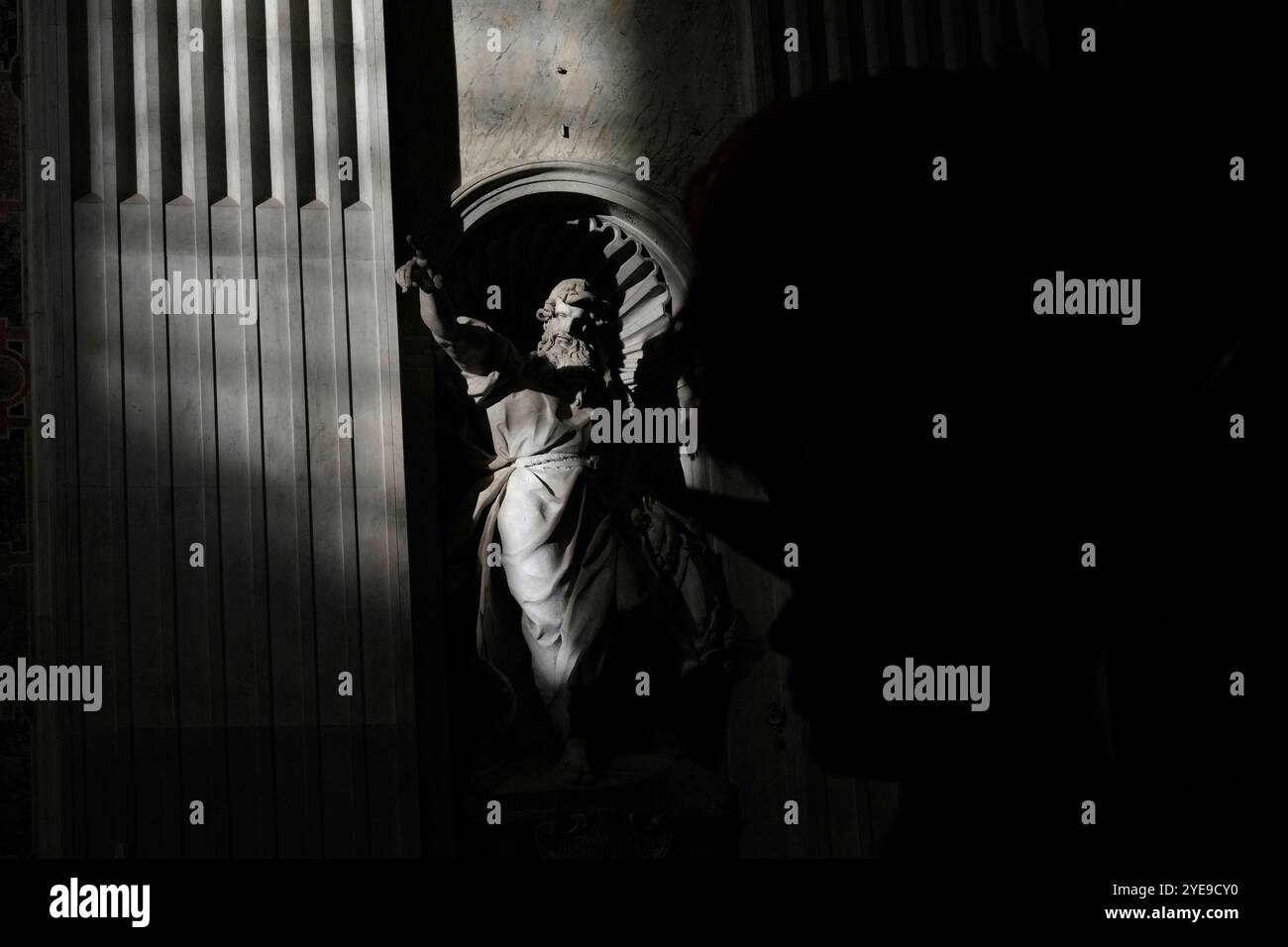 A statues is Illuminated by a ray of sun during the funeral of late ...