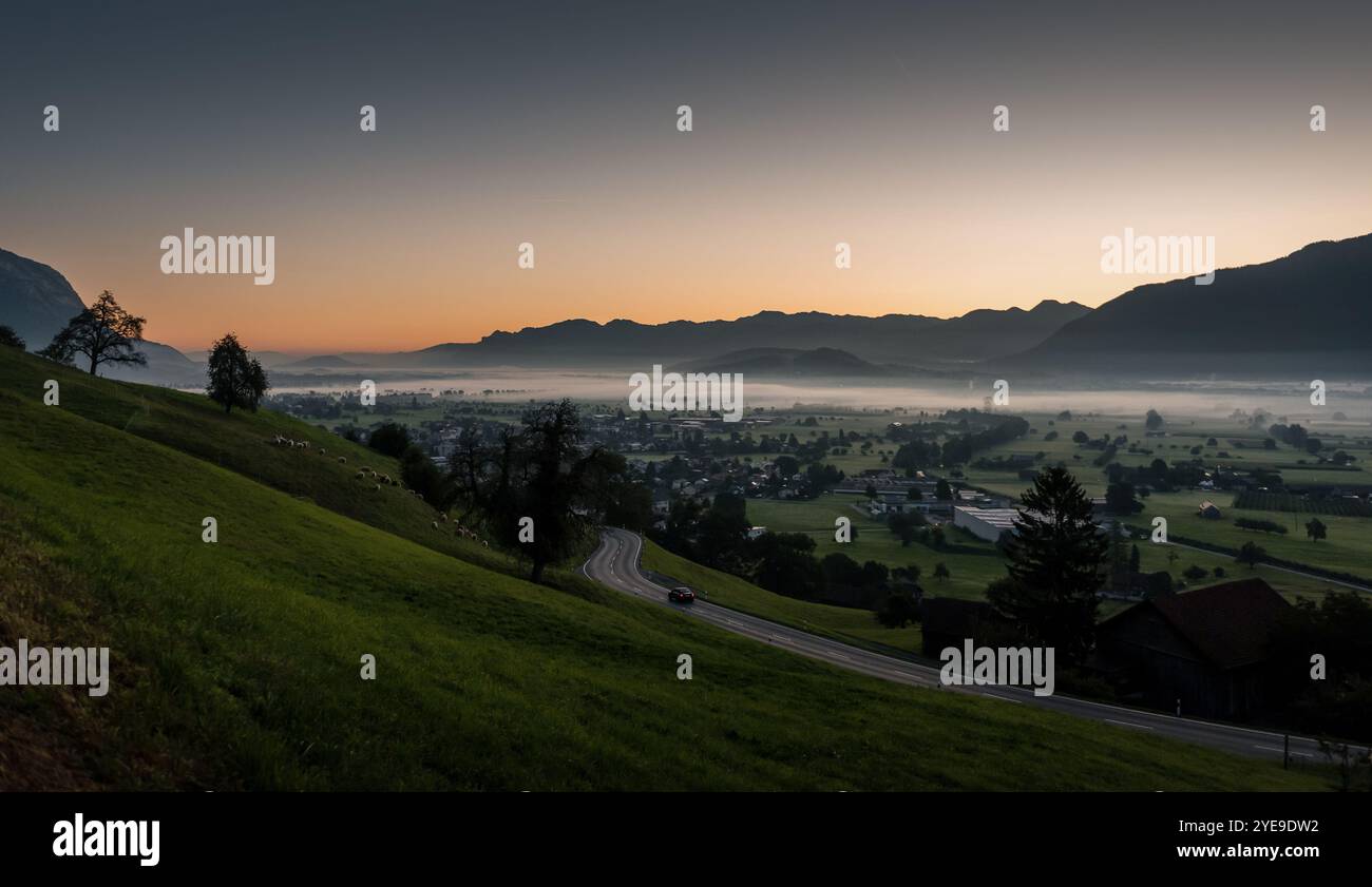 Dawn at Alpine Rhine Valley. Panorama of mountain valley covered in fog ...