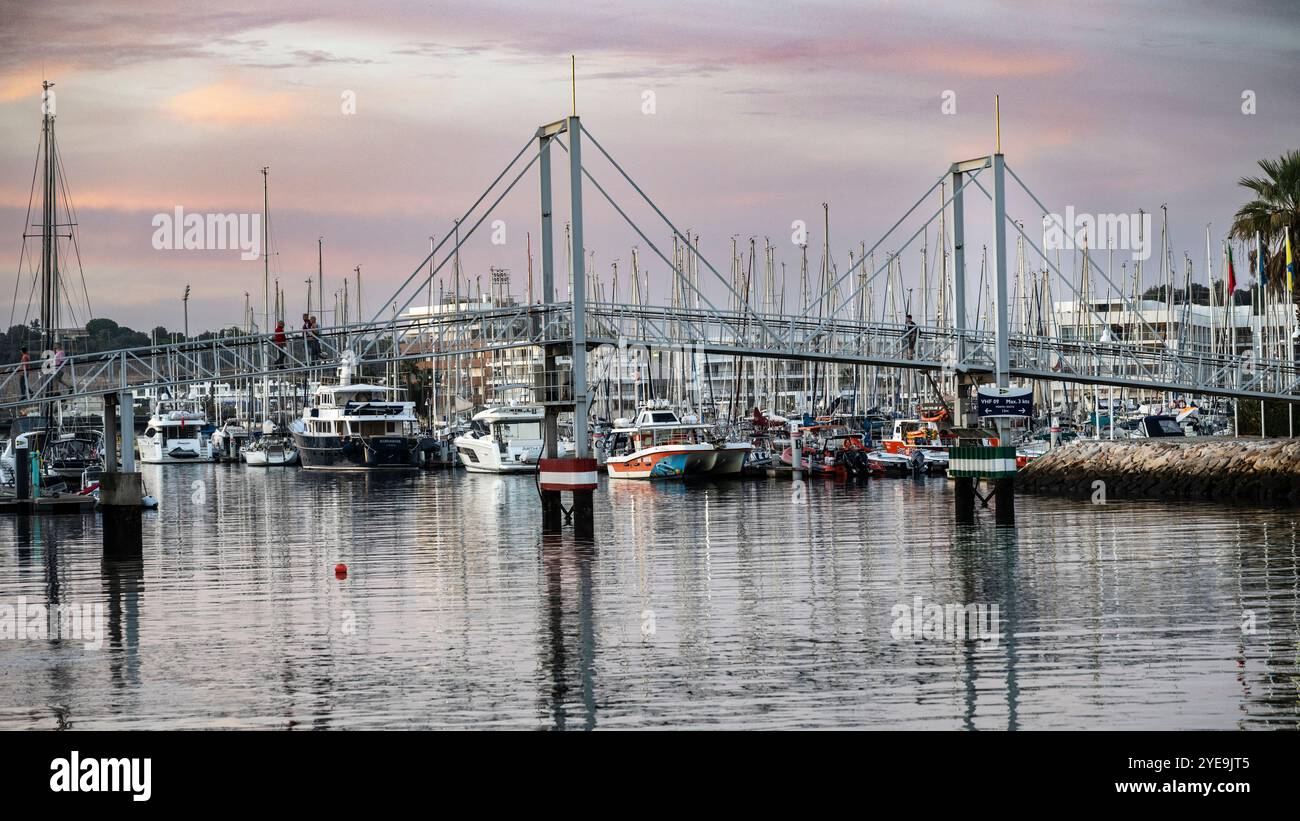 Footbridge over the harbour in the coastal town of Lagos at twilight ...