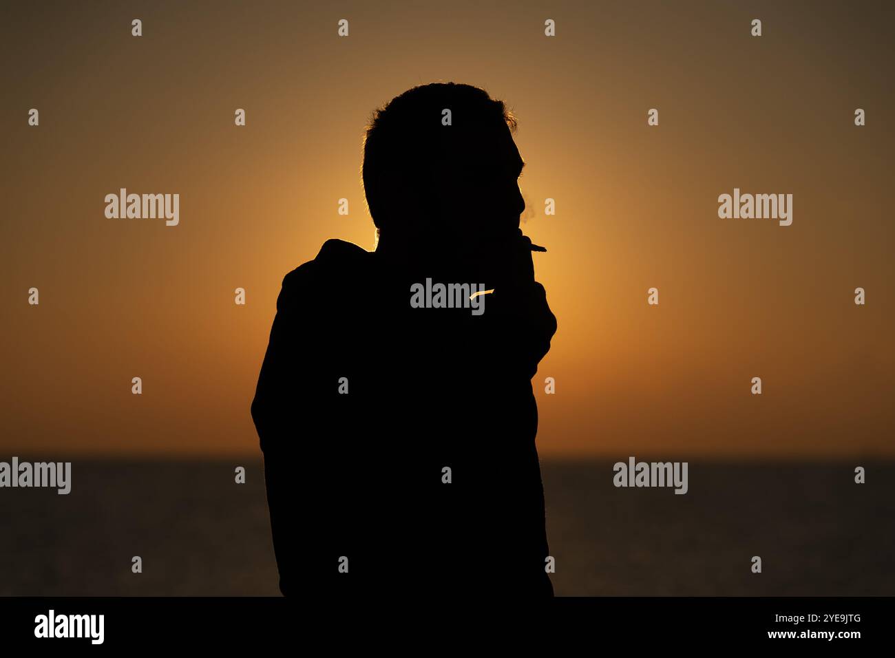 Man smoking in shadows hi-res stock photography and images - Alamy
