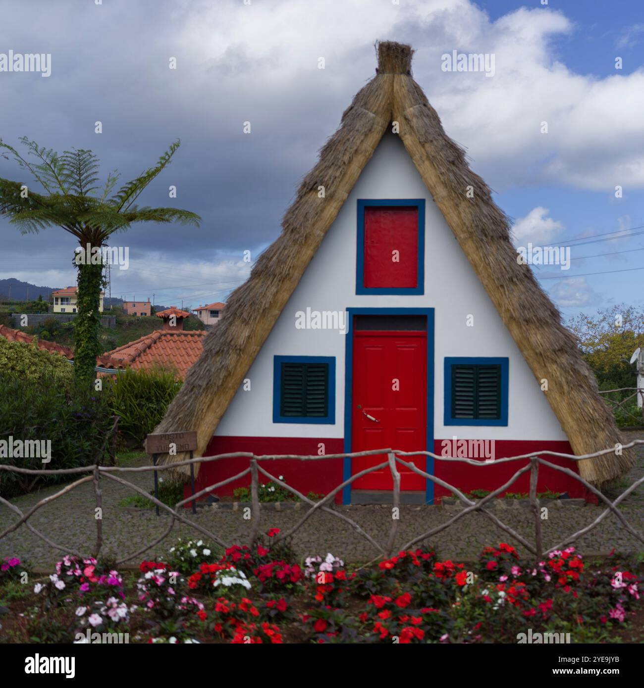 A-Frame house with red door and thatched roof; Santana, Madeira ...