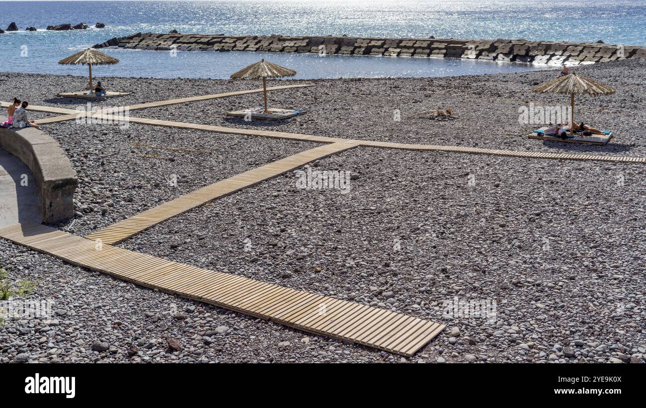 Waterfront and pebble beach at Ponta do Sol on the island of Madeira ...