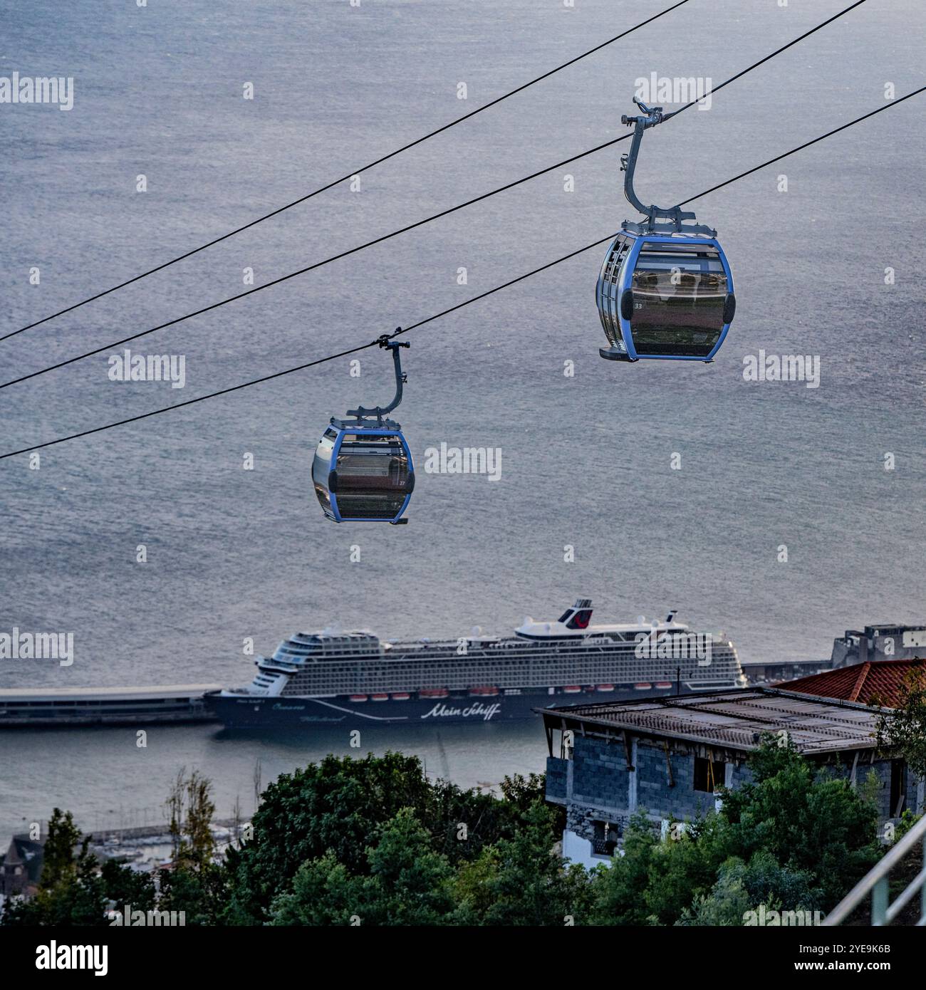 Aerial tramway and cruise ship in the sea port of Funchal on the island ...