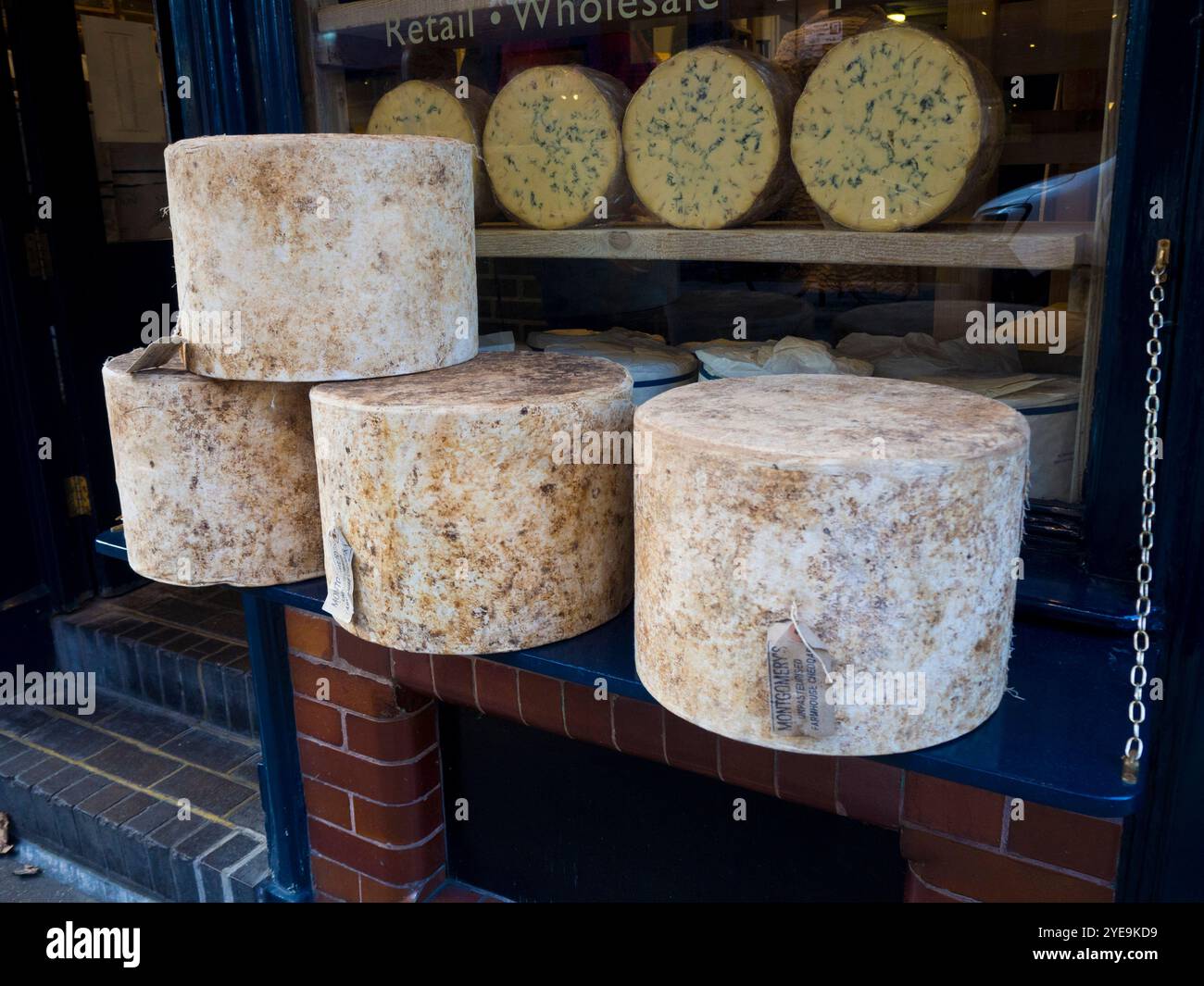 Wheels of mature cheddar cheese with labels on display, Neal's Yard ... Wheels of mature cheddar cheese with labels on display, Neal's Yard ...