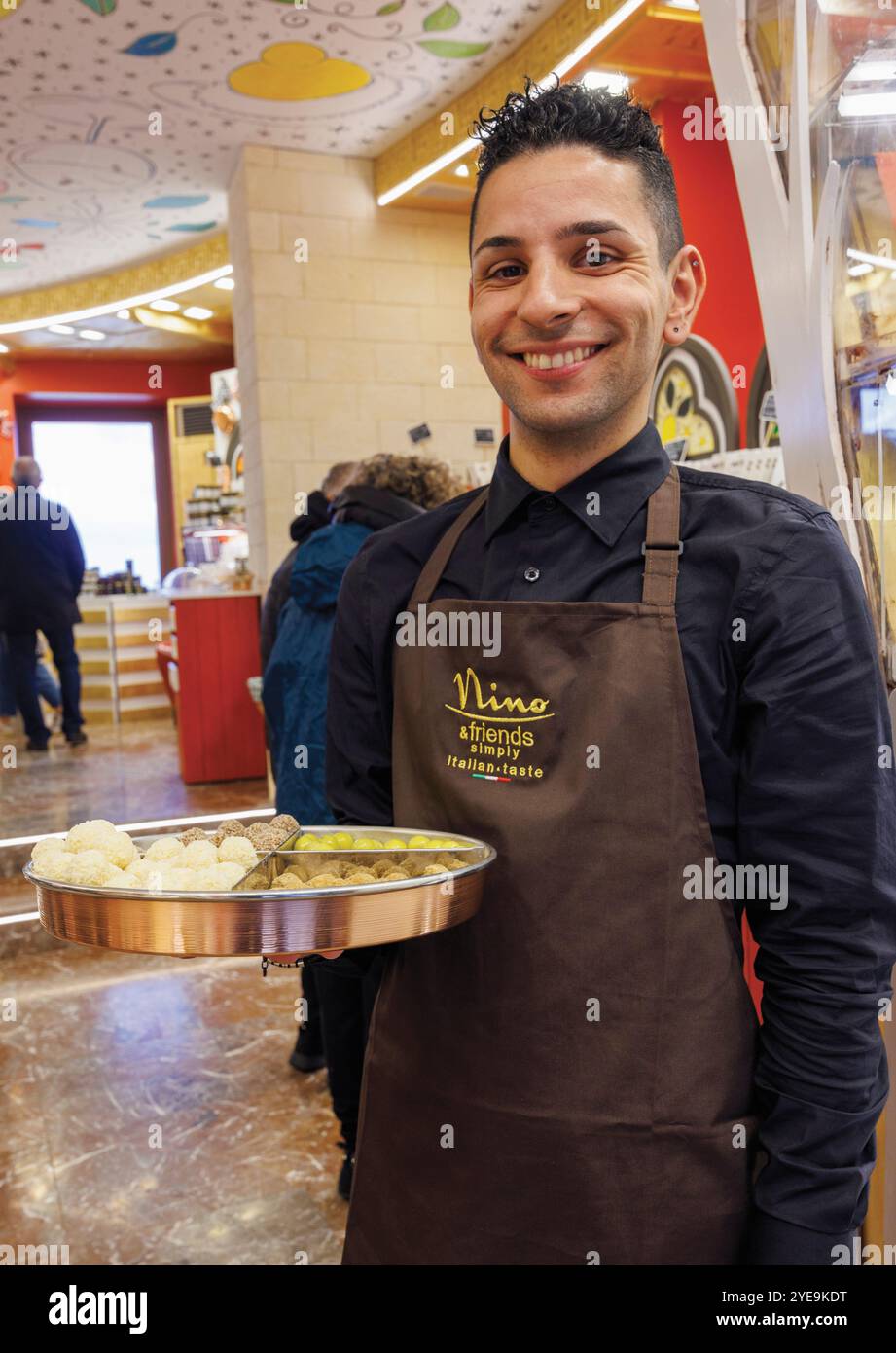 Food attendant with samples at Nino and Friends, the shop specializes ...