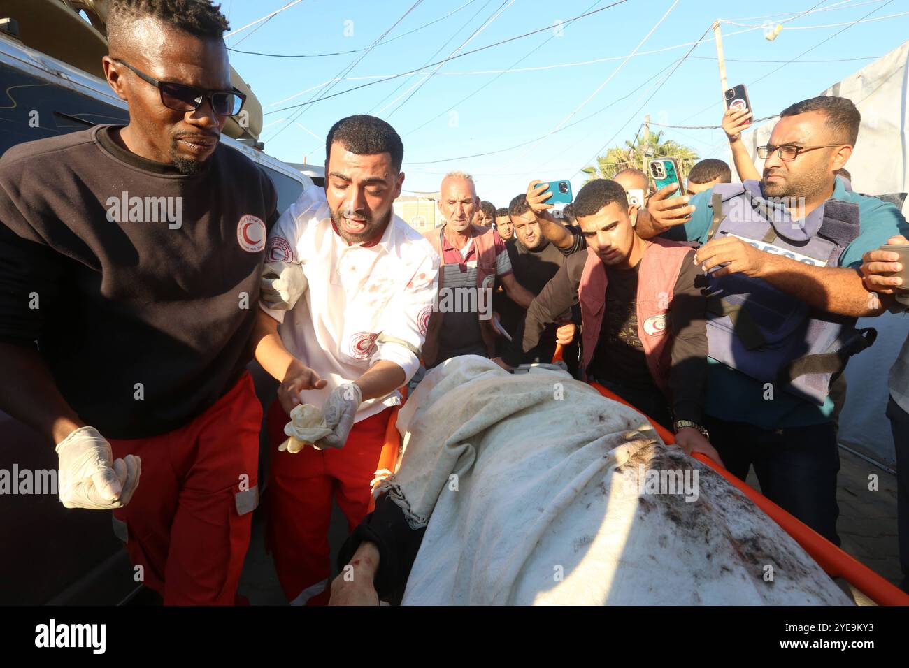 A Palestine Red Cresent Society member mourns over the body of his ...