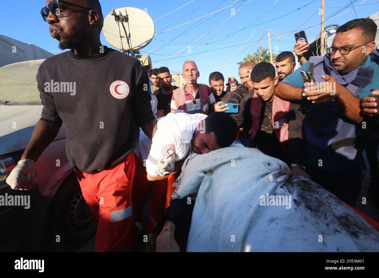 A Palestine Red Cresent Society member mourns over the body of his ...