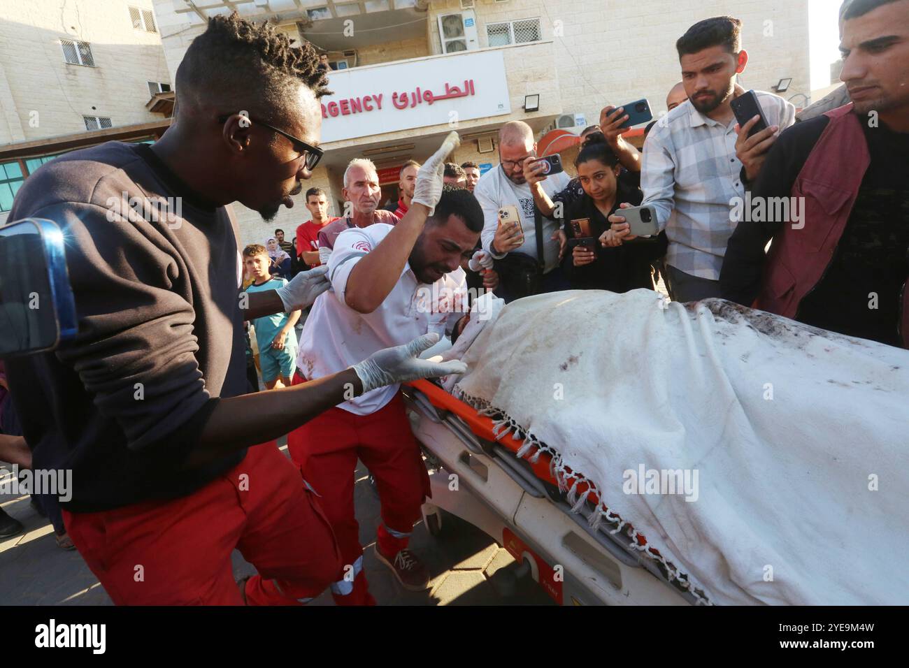 A Palestine Red Cresent Society member mourns over the body of his ...