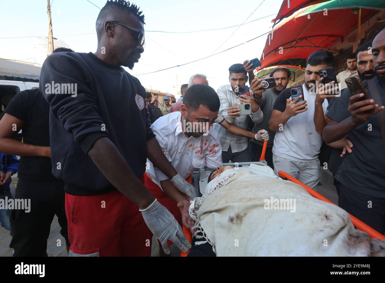 A Palestine Red Cresent Society member mourns over the body of his ...