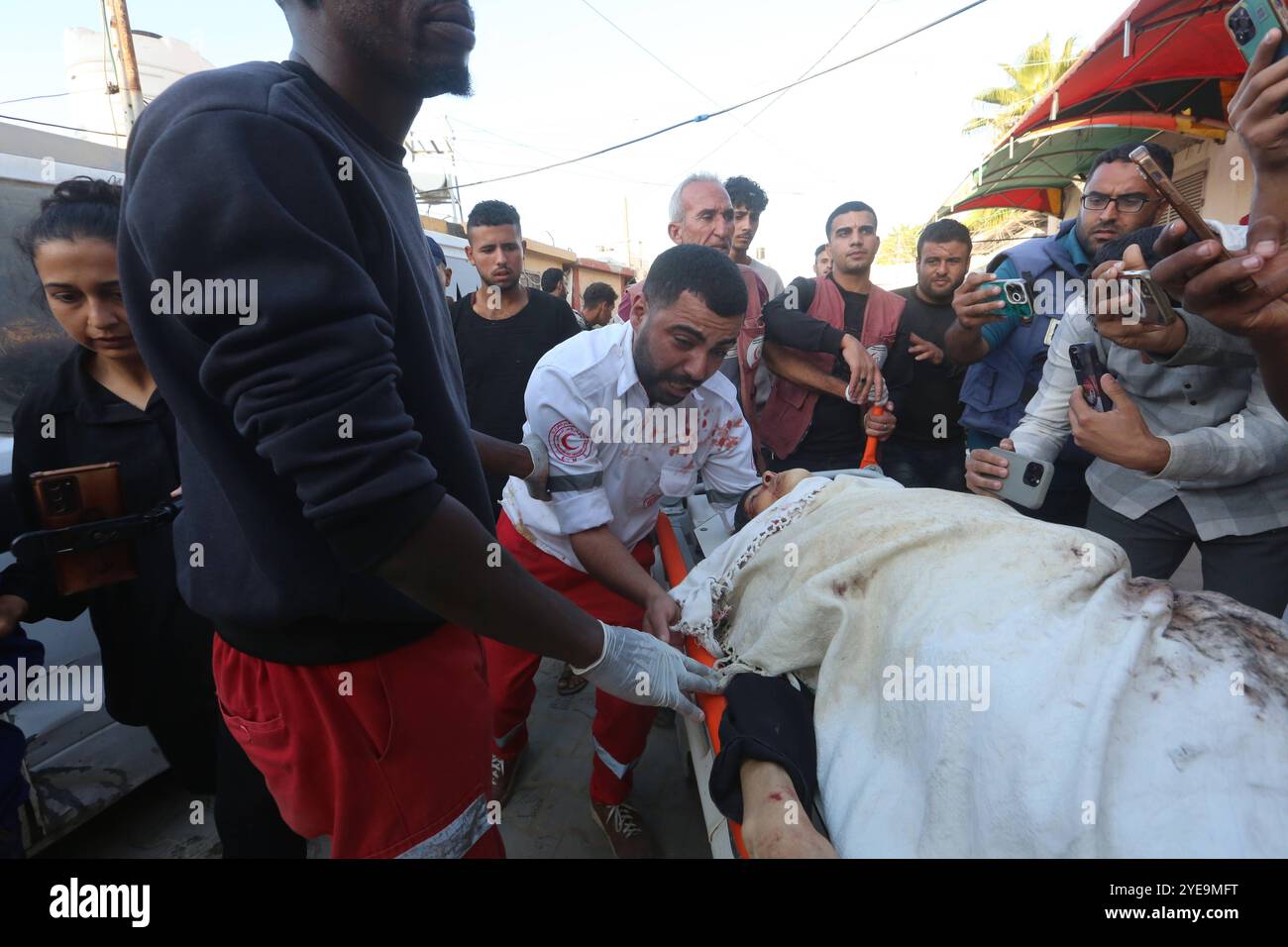 A Palestine Red Cresent Society member mourns over the body of his ...