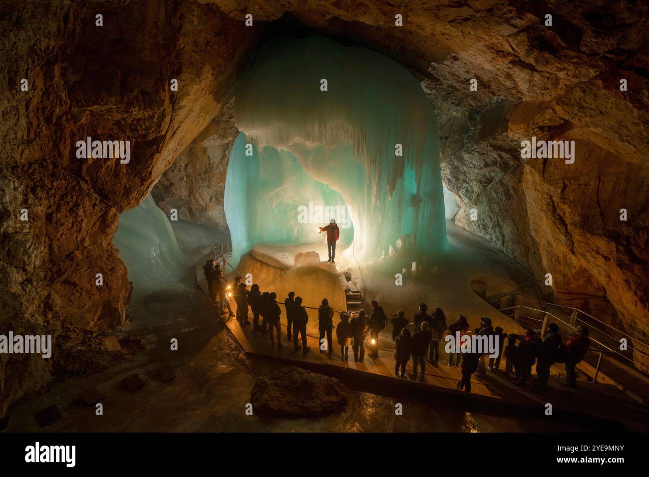 Guide with a tour group in a show cave in the ice caves of the European ...