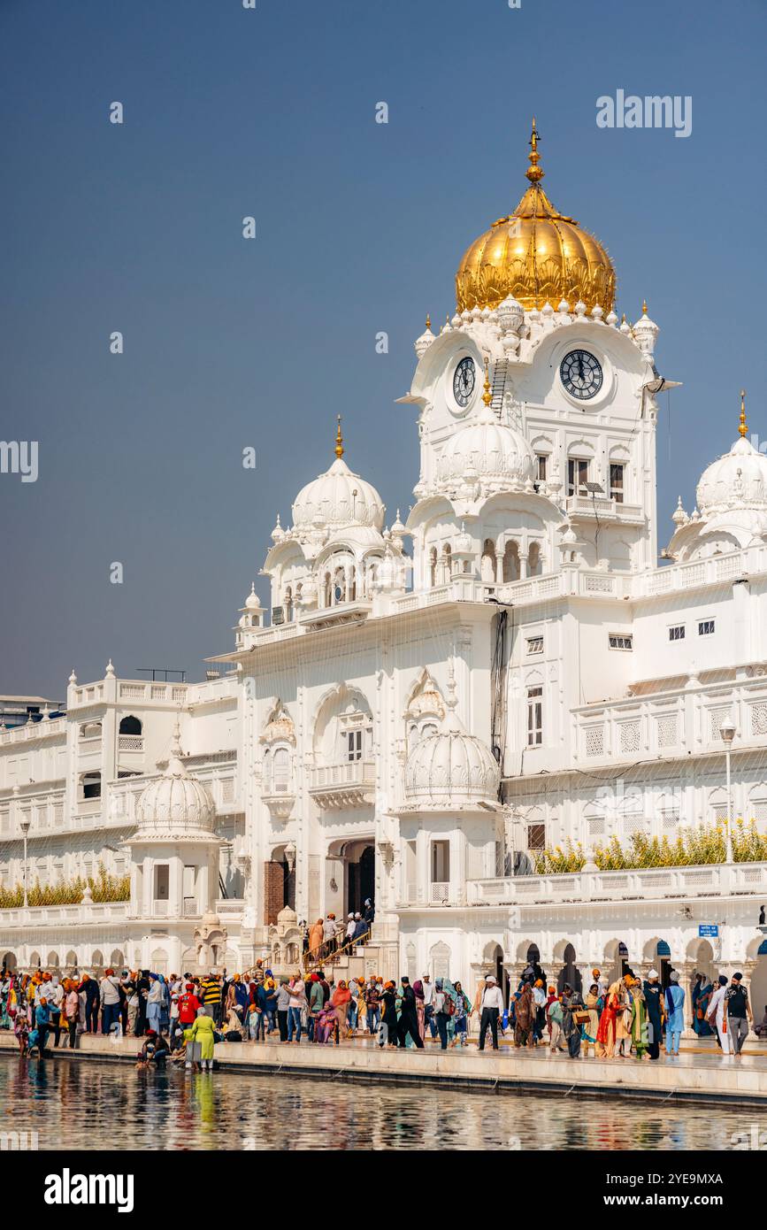 Golden Temple, a Sikh Gurdwara with people entering the water, in ...