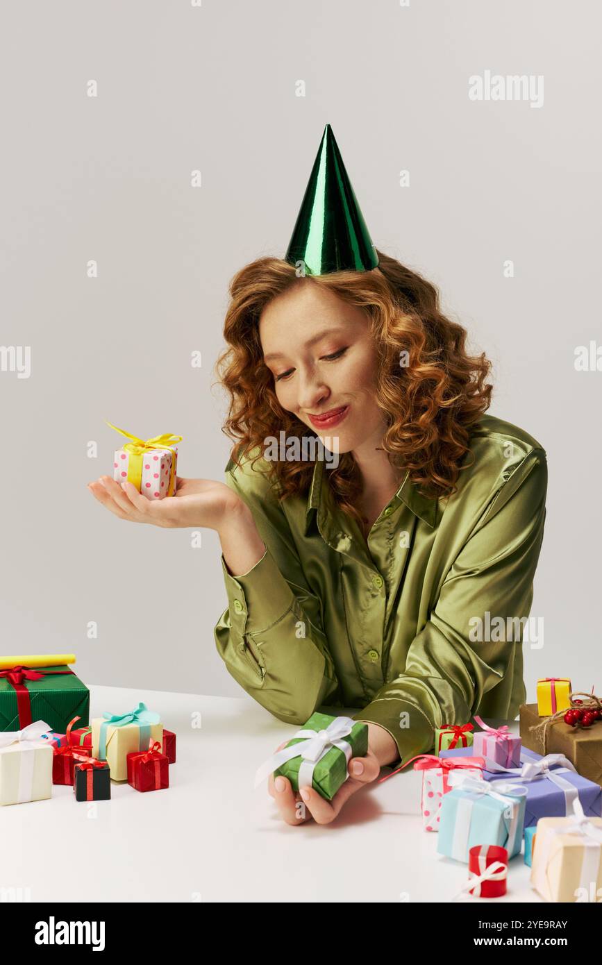 A cheerful young woman in party attire posing surrounded by decorations ...